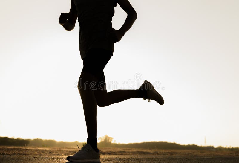 A Man Running on the Asphalt Road at Sunset Stock Photo - Image of ...