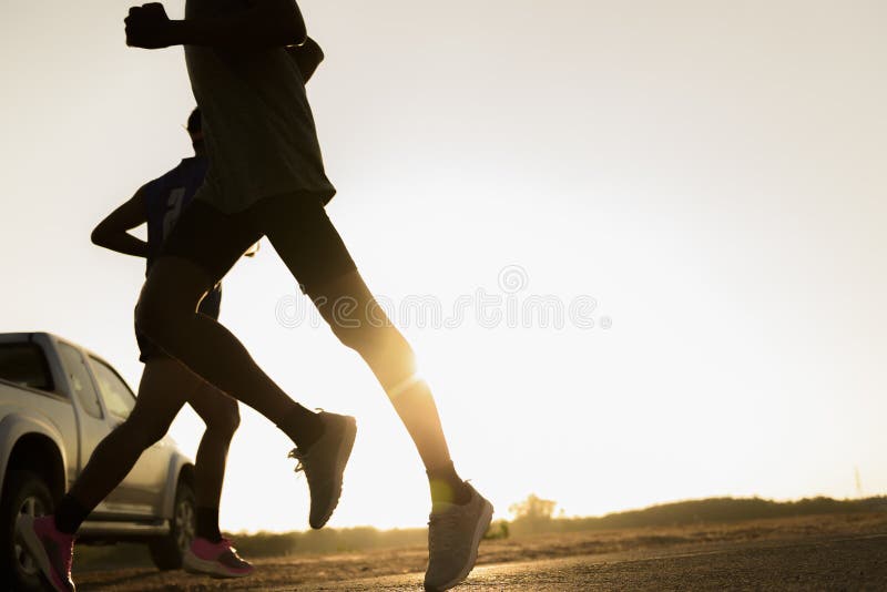 A Man Running on the Asphalt Road at Sunset Stock Photo - Image of ...