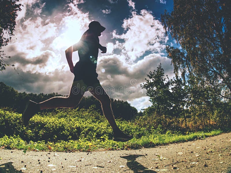 Man Running on Asphalt Track. Athlete Running Fast in a Park Stock ...