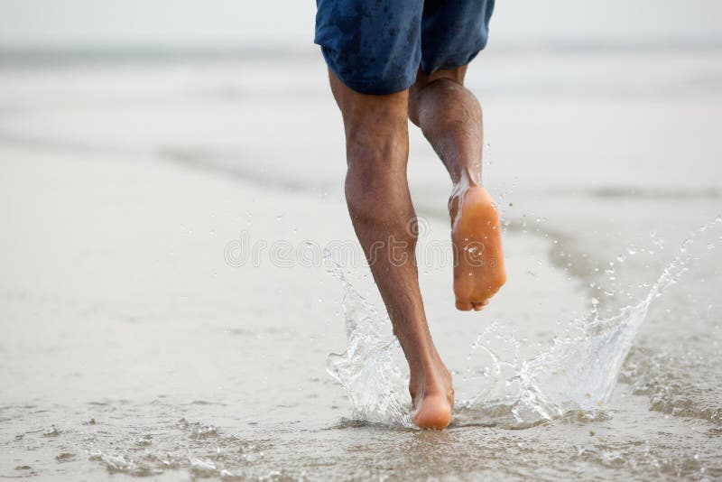 Man Running Barefoot in Water Stock Image - Image of exercise, person ...
