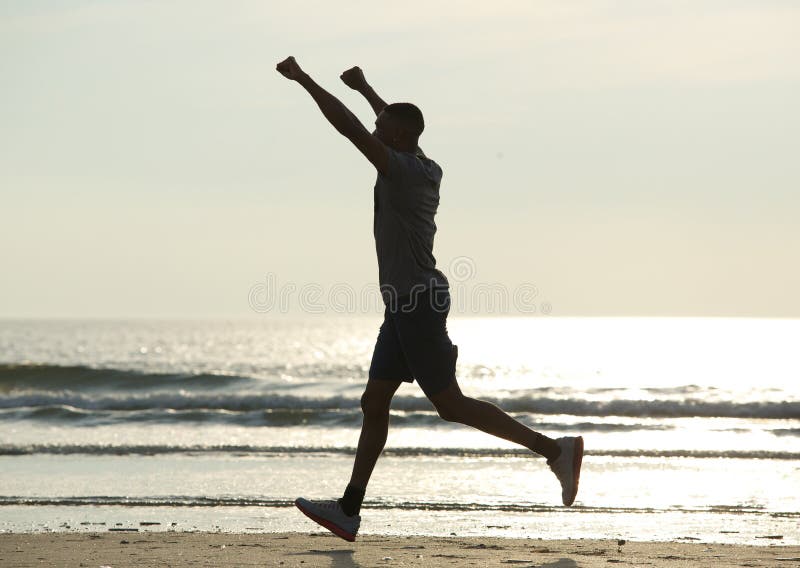 Man Running on Beach with Arms Raised Stock Photo - Image of fitness ...
