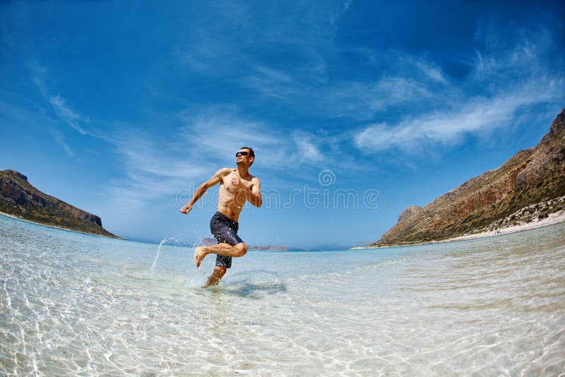 Man running on the beach stock photo. Image of lifestyle - 72741460