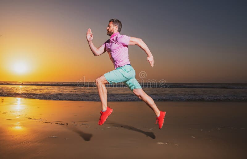 Man Running on the Beach at Sunset. Guy Runner Jogger Running. Dynamic ...