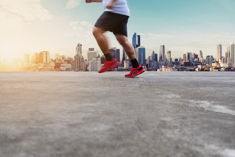 A Man Running on Concrete Road with City View in Sunrise, Selective ...
