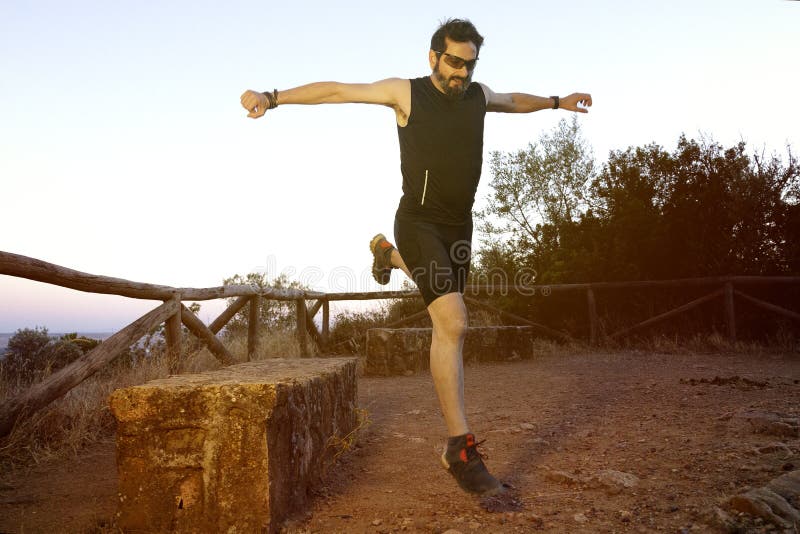 Man Running through the Countryside with Rock Formations in the ...