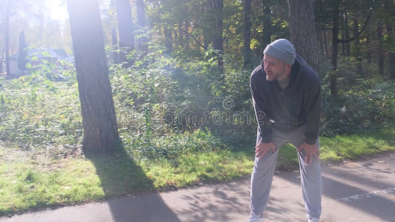 Man Running through a Fall Forest in Activewear. Trees Surround the ...