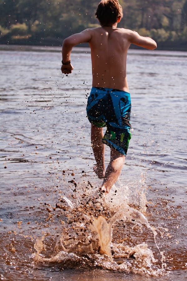 Man running in lake stock image. Image of water, splashes - 24315363