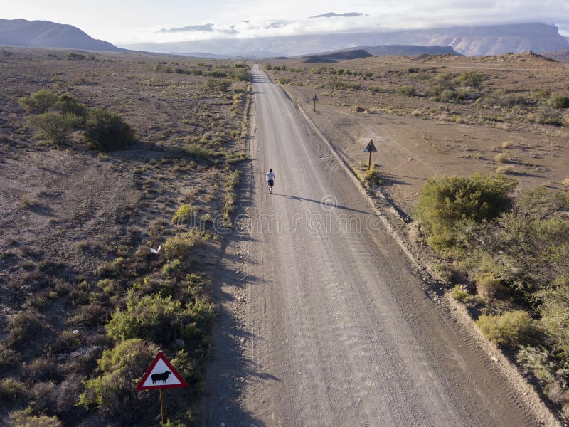 Man Running on an Open Empty Road in Arid Landscape Stock Image - Image ...