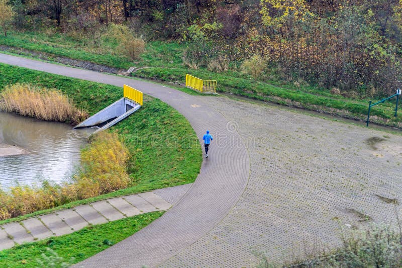 A Man is Running in the Park Stock Photo - Image of jogging, lifestyle ...