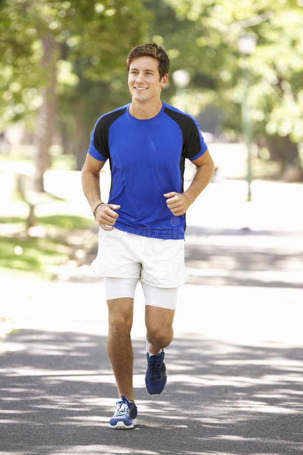 Man Running through Park stock image. Image of person - 55896167