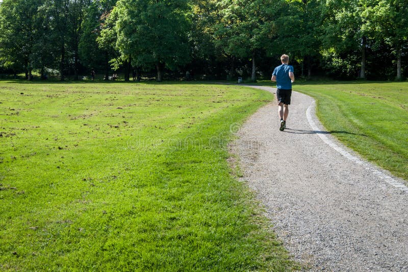Man running in a park editorial stock image. Image of fitness - 96889989