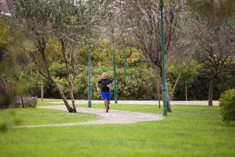 Man Running at the park stock image. Image of athlete - 183157509