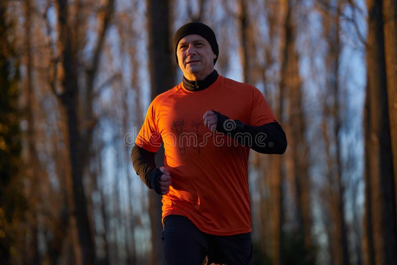Man Running in the Park in Wintertime Stock Image - Image of grass ...