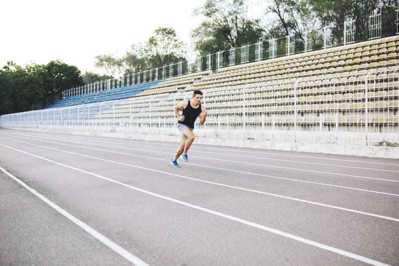 Man Running on a Racing Track Stock Image - Image of muscular ...