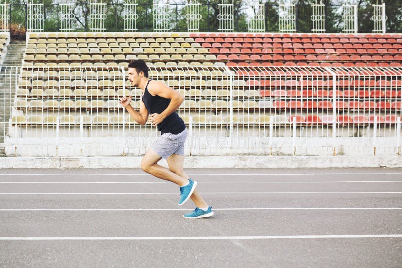 Man Running on a Racing Track Stock Image - Image of power, sport: 66367097