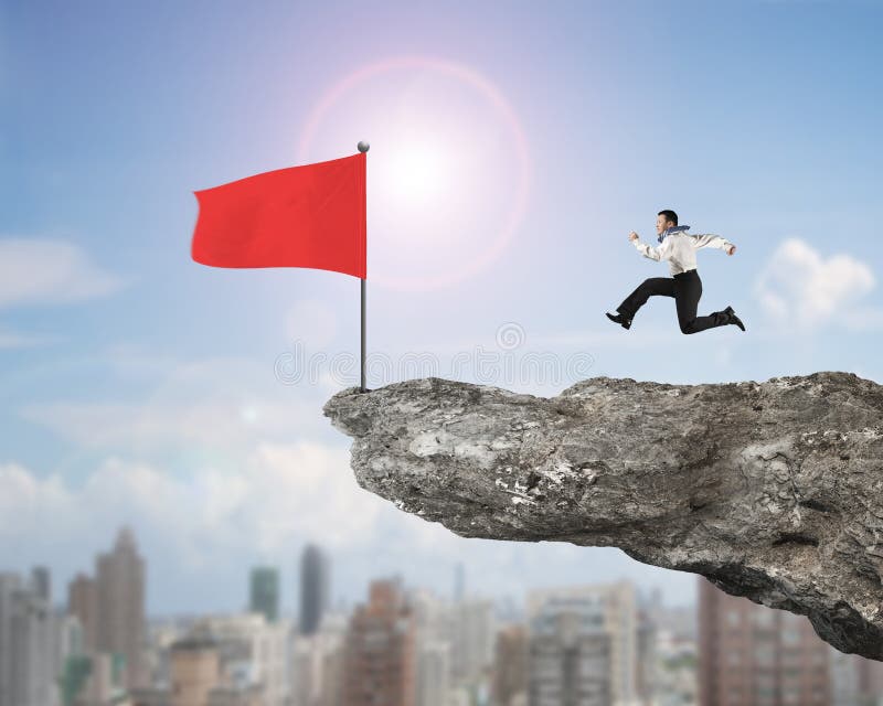 Man Running for Red Flag on Cliff with City View Stock Photo - Image of ...