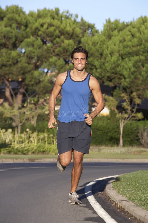 Man Running on Road stock photo. Image of male, park - 54935992