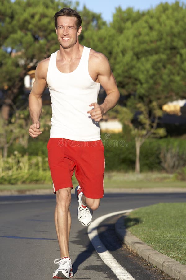 Man Running on Road stock photo. Image of male, outdoor - 55891022