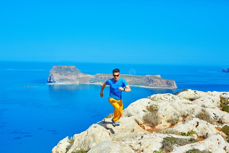 Man running on the rock stock photo. Image of seashore - 70274032