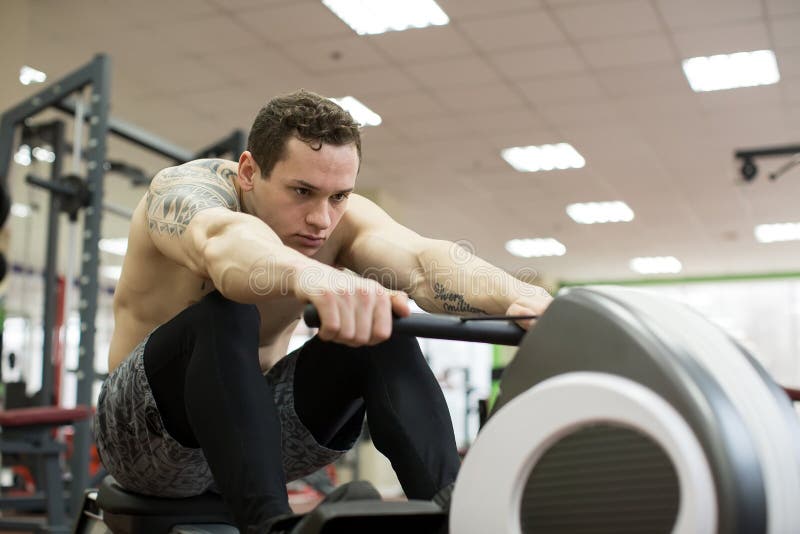 Man Running Rowing Exercise in the Gym. Stock Photo - Image of male ...