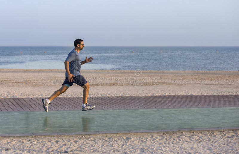 Man Running on a Running Track Near Beach Stock Photo - Image of runner ...