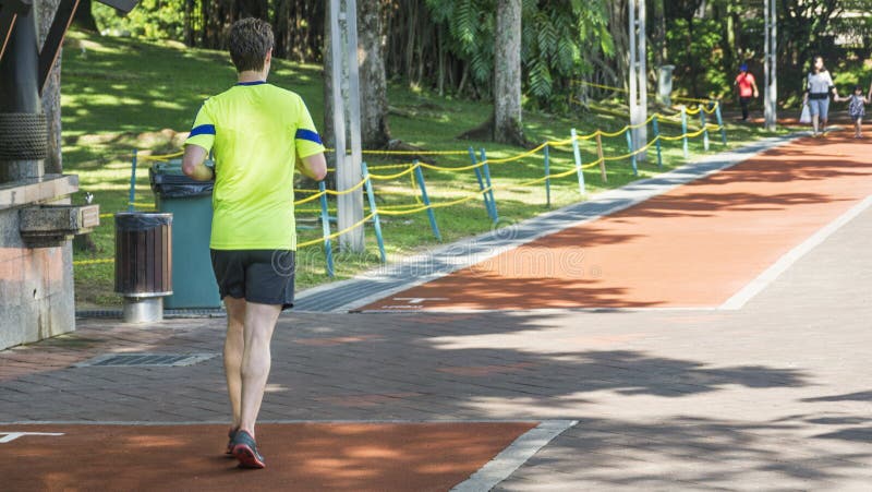 Man Running in the Running Way in the Garden Park. Editorial Stock ...