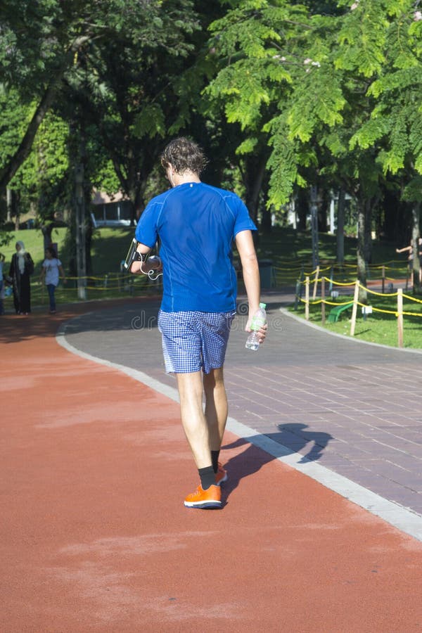 Man Running in the Running Way in the Garden Park. Editorial Stock ...
