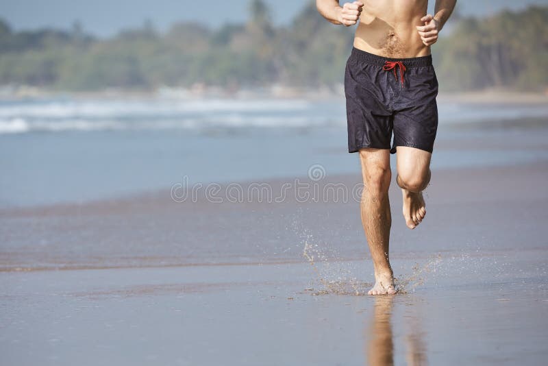 Man running on sand beach stock image. Image of adult - 243607045