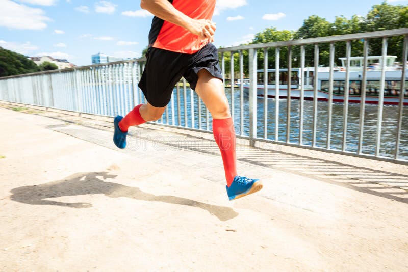 Man Running on Sidewalk at Morning Stock Photo - Image of compression ...