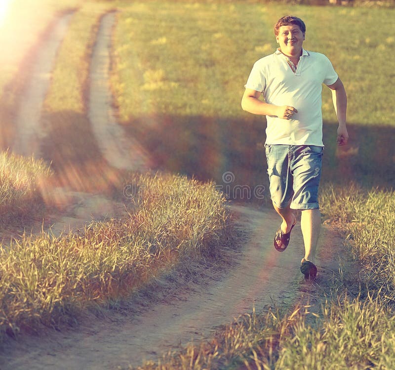 Man Running in Sunset Summer Field Stock Photo - Image of sports ...