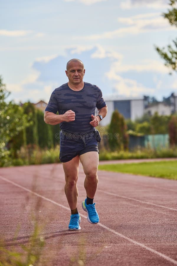Man Running on a Running Track Stock Photo - Image of life, effort ...