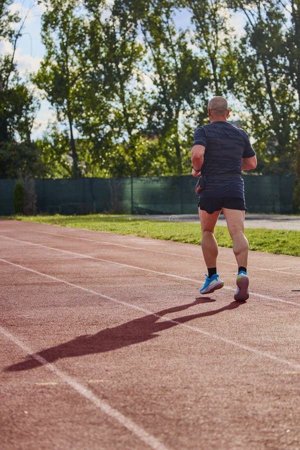 Man Running on a Running Track Stock Photo - Image of modern, endurance ...