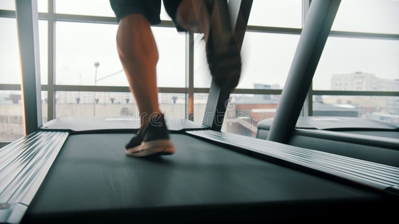 A Man Running on the Treadmill in Front of Big Windows Stock Video ...