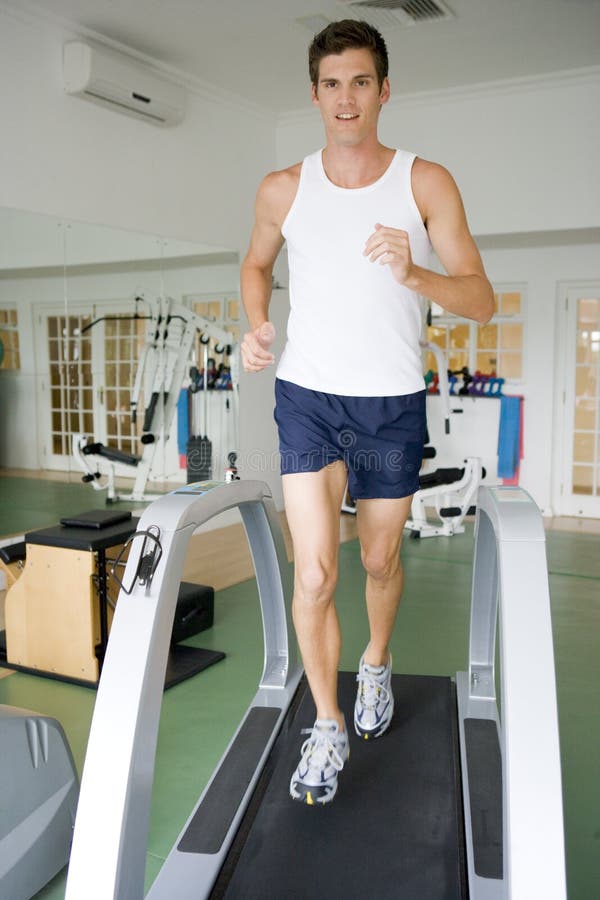 Man Running on Treadmill at Gym Stock Photo - Image of smiling, looking ...