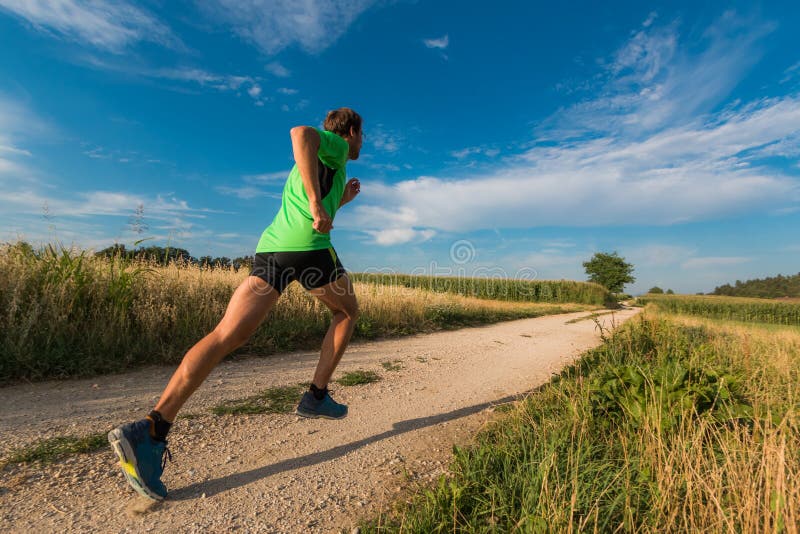 The Man Running on the Unpaved Country Road Stock Photo - Image of ...