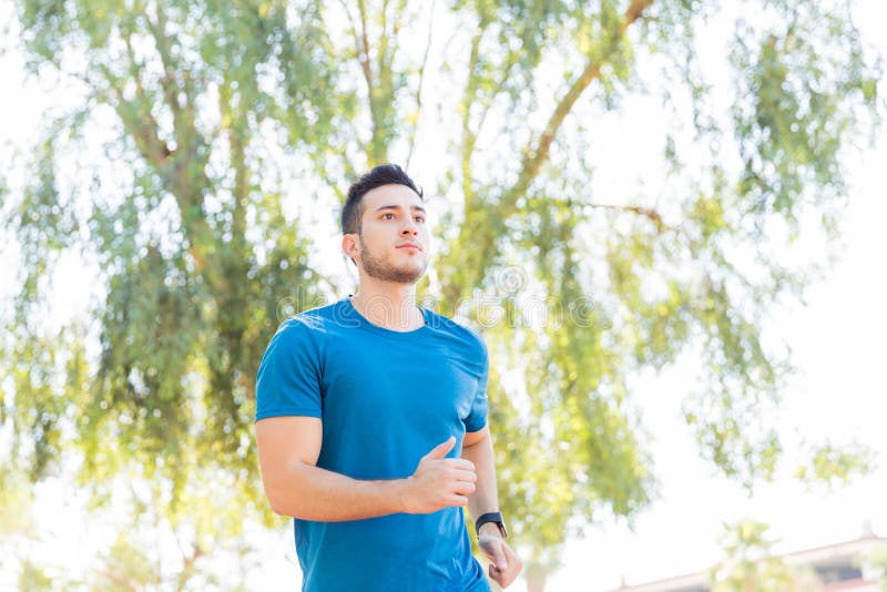Man Running and Working Out Against Tree in Park Stock Photo - Image of ...
