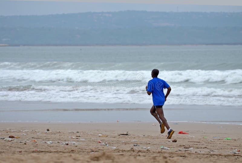 Man Runs Along a Dirty Sandy Beach after a Storm Editorial Photography ...