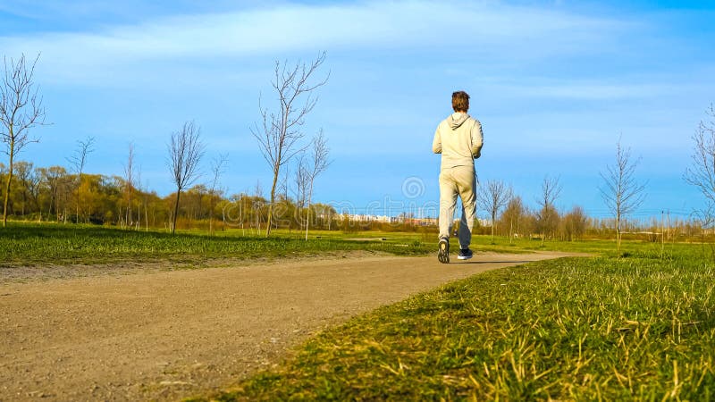 A Man Running Down a Path in a Park. AI Generative Image Stock ...