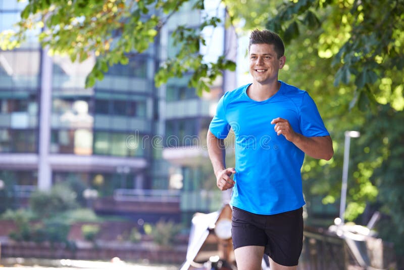 Man Running by River in Urban Setting Stock Image - Image of thirties ...