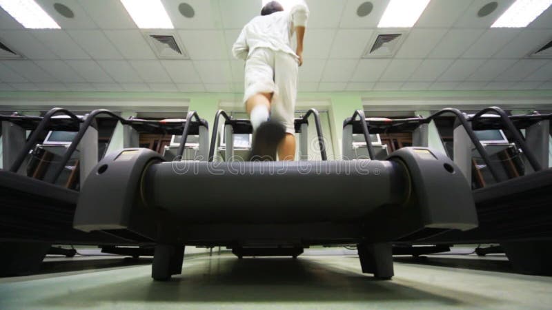 Man Runs on Treadmill in Big Empty Gym , Bottom Stock Footage - Video ...