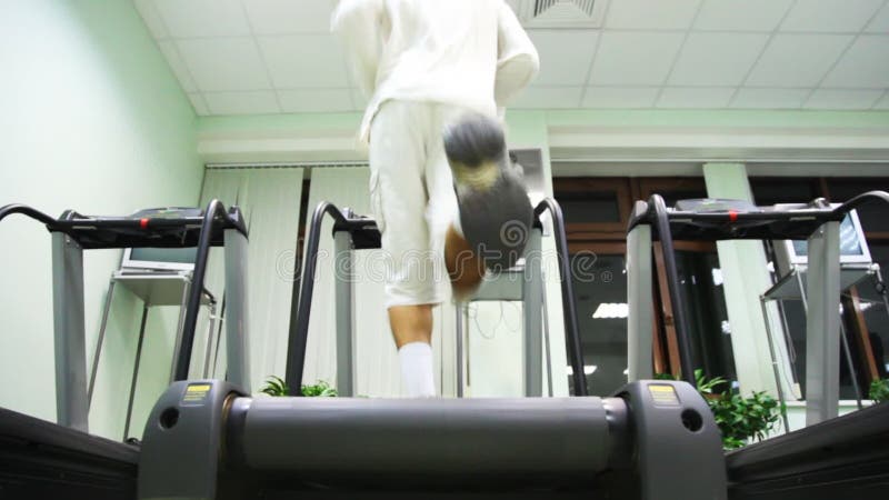 Man Runs on Treadmill in Large Empty Gym, Back Stock Video - Video of ...