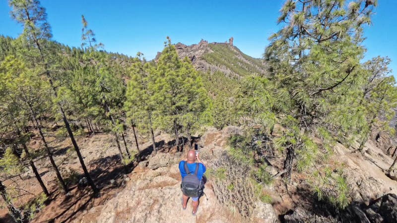 A Man S Back View while Filming a Video of Nature Landscape on a ...