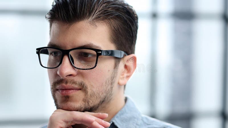 A Man S Face in Close-up with Glasses Looks Thoughtfully Away Stock ...