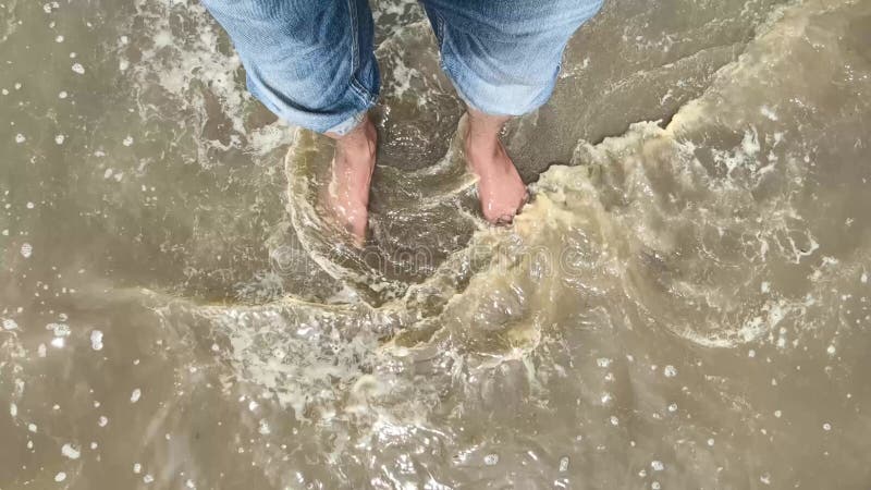A Man S Feet Hit by the Waves on the Beach Stock Footage - Video of ...