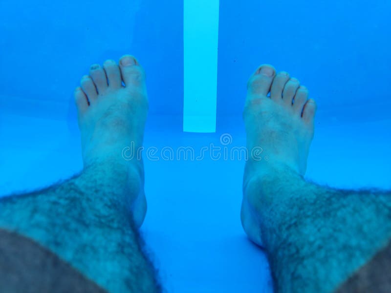 Man s feet in the pool stock photo. Image of body, water - 255316382
