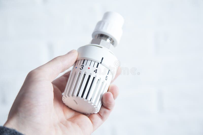 Man`s Hand Adjusting Radiator Thermostat Valve at Home Stock Image ...