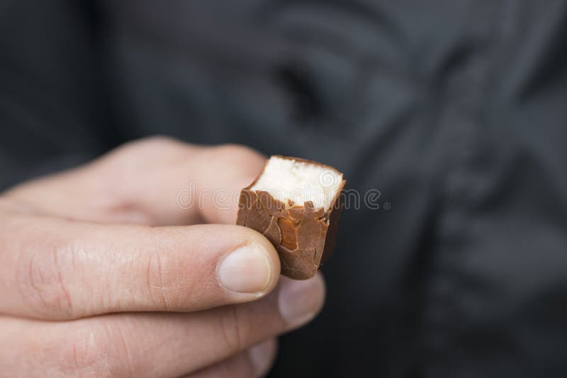 Man`s Hand Bitten by a Chocolate Candy Stock Image - Image of pile ...