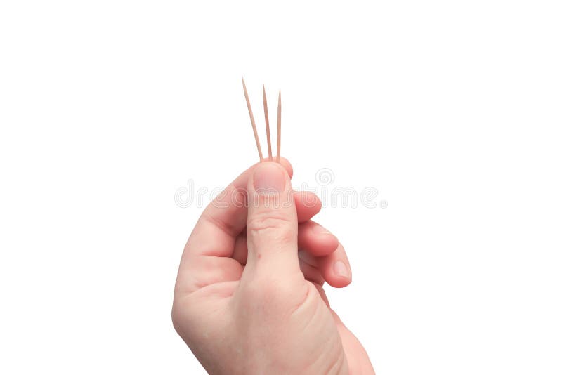 A Man`s Hand with Close-up Toothpicks. Three Sharp Wooden Sticks in His ...
