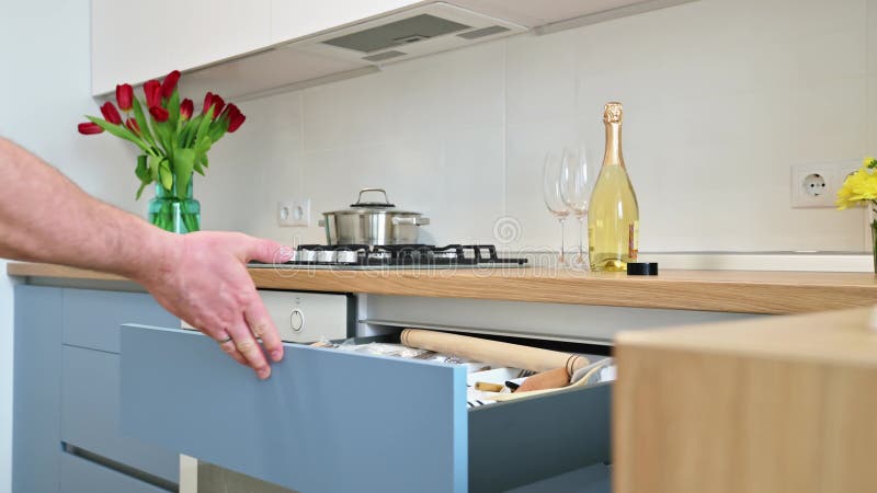 Man S Hand Closing a Drawer at Modern Blue-teal and White Kitchen Stock ...
