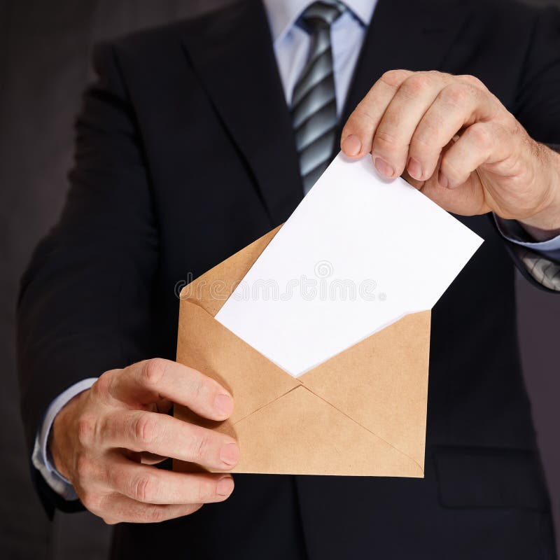 A Man Puts A White Sheet Of Paper In An Envelope Stock Image - Image of ...